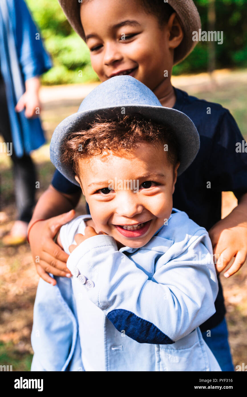 Two happy brothers hug each other outdoor close up Stock Photo - Alamy