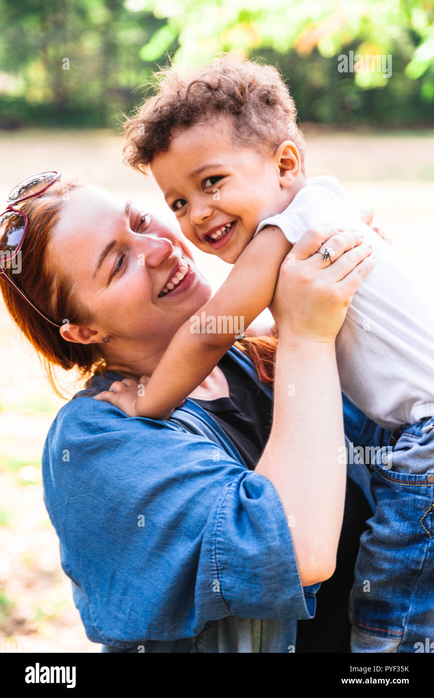 Mother and son having fun in park. International family Stock Photo - Alamy