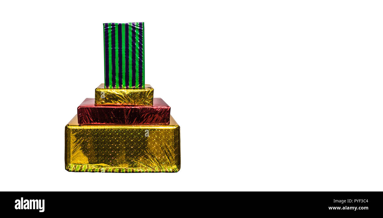 A stack of wrapped gift boxes in green, red and gold on a white ...
