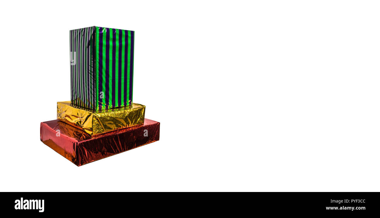 A stack of wrapped gift boxes in green, red and gold on a white ...
