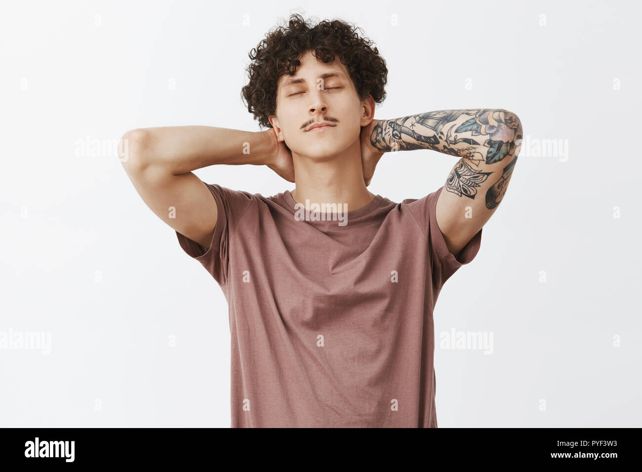 Guy feeling relieved stretching after sitting too long at work holding ...