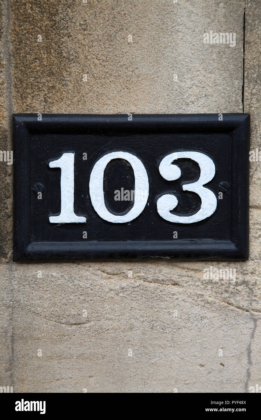 One Hundred and Three Number Sign on Stone Wall Stock Photo - Alamy