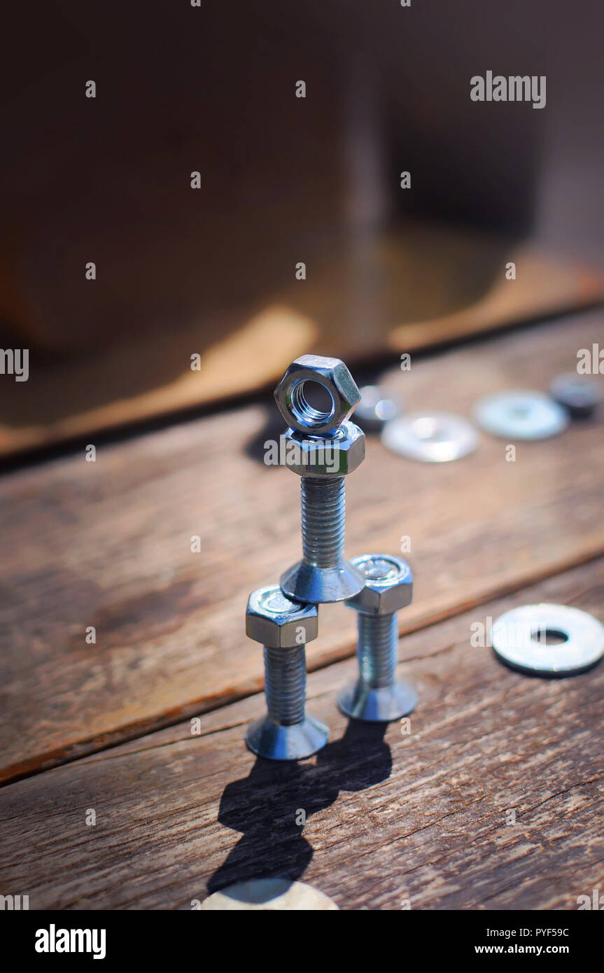 A figure of one small robot assembled from several bolts and nuts ...
