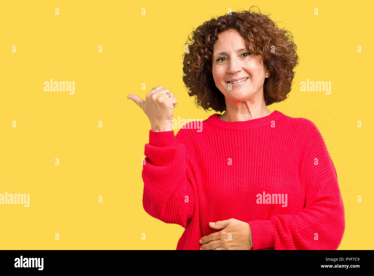 Beautiful middle ager senior woman red winter sweater over isolated ...