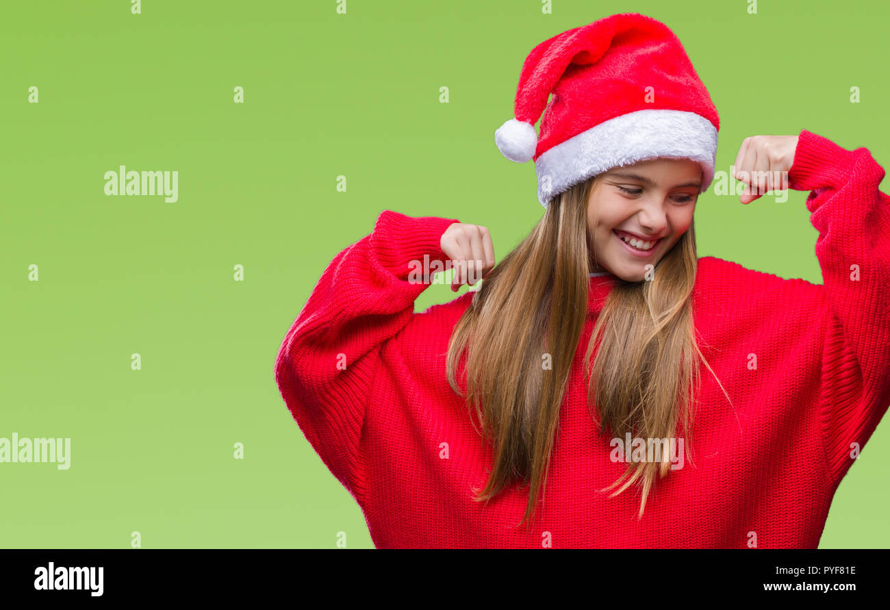 Young beautiful girl wearing christmas hat over isolated background ...