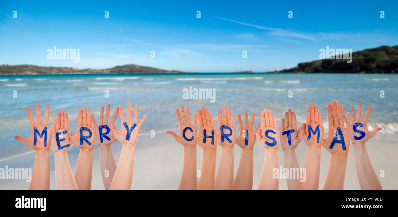 Many Hands Building Word Merry Christmas, Beach And Ocean Stock Photo ...
