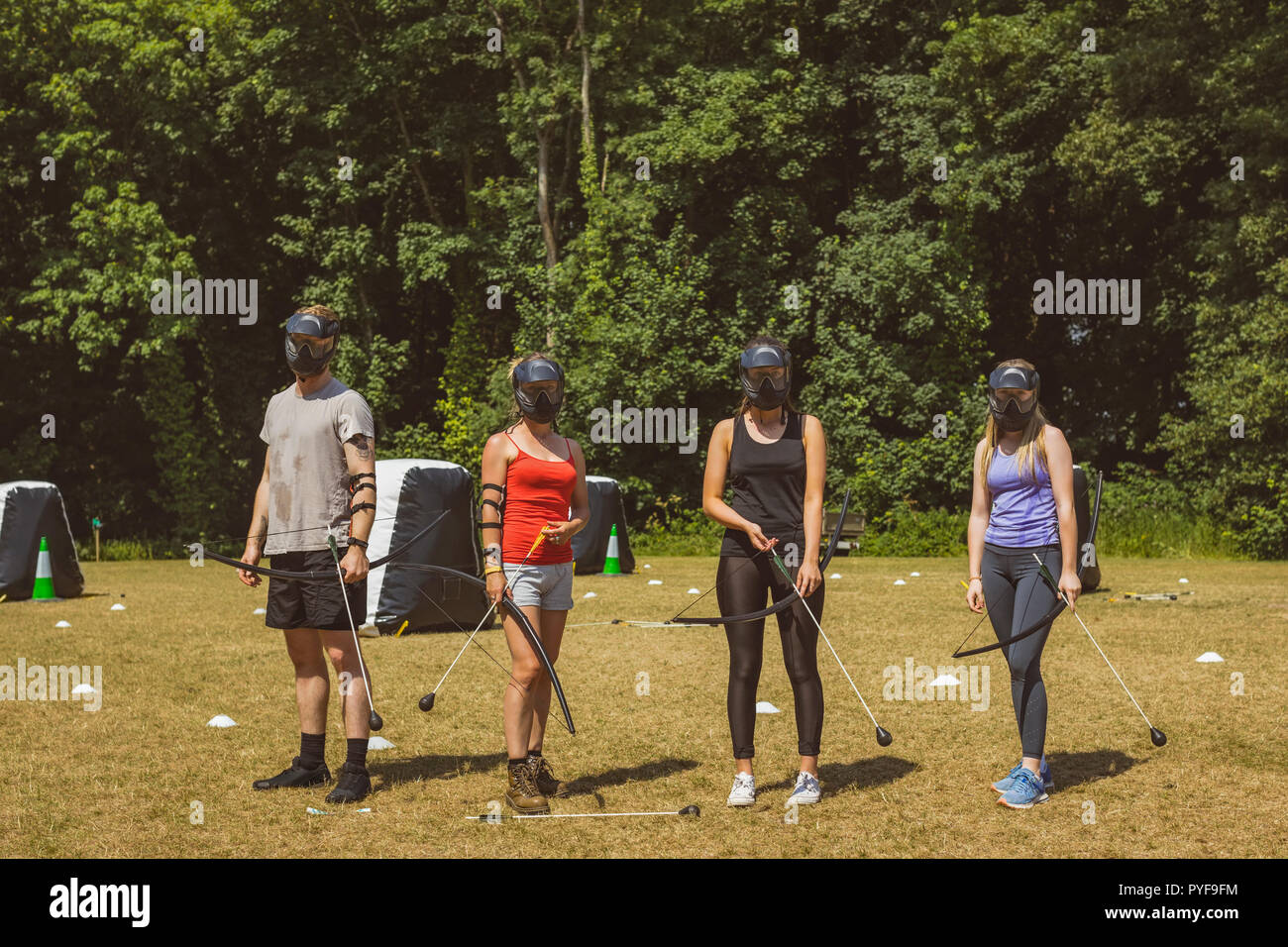 Group of people practicing archery at boot camp Stock Photo - Alamy
