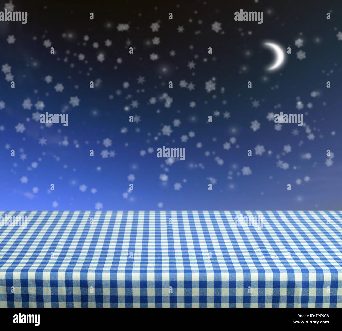 Empty wooden table at night sky with moon and snowflakes. Great for ...