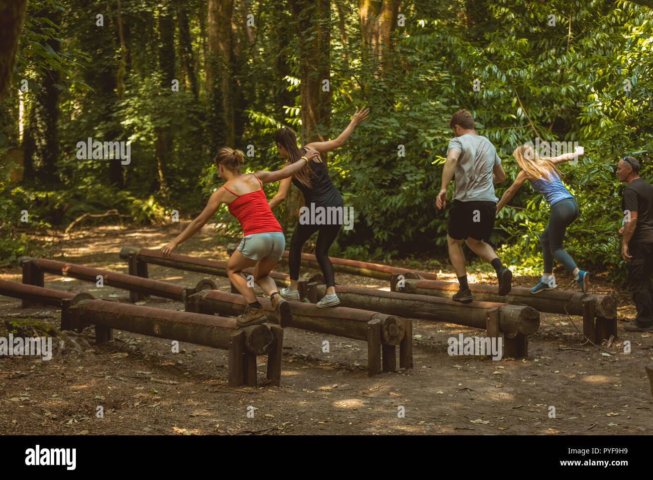 Fit people training over obstacle course Stock Photo - Alamy