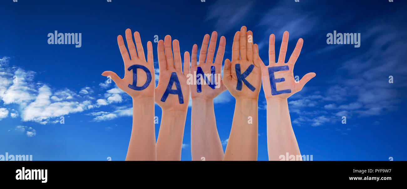 Many Hands Building Danke Means Thank You, Blue Sky Stock Photo - Alamy