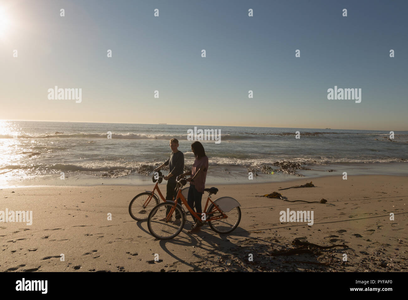 Couple with bicycle hi-res stock photography and images - Alamy