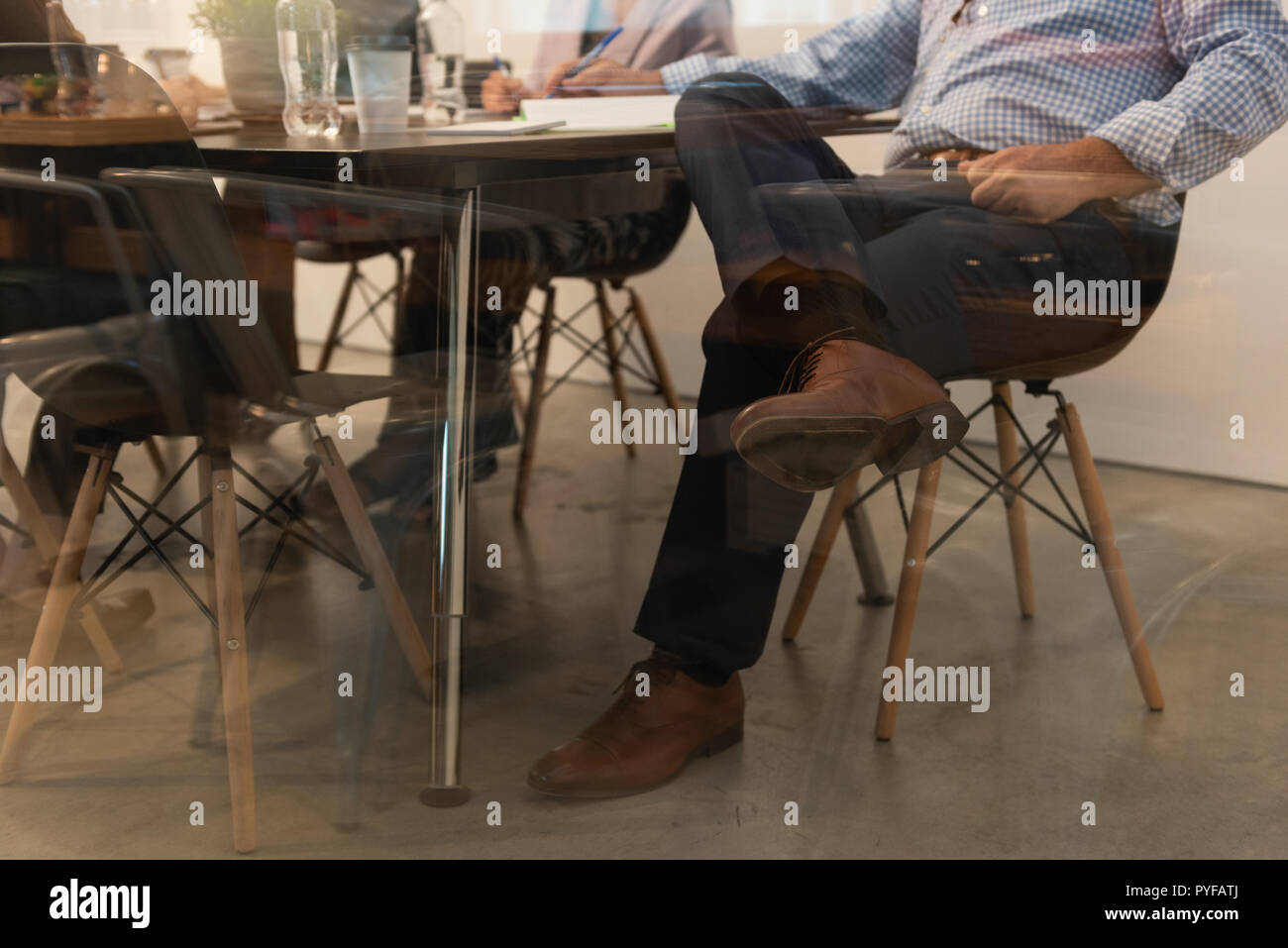 Executive sitting on chair in conference room at office Stock Photo - Alamy