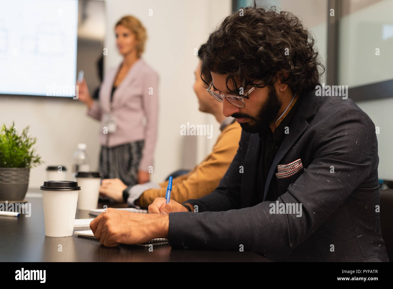 Male executive writing on notepad Stock Photo - Alamy