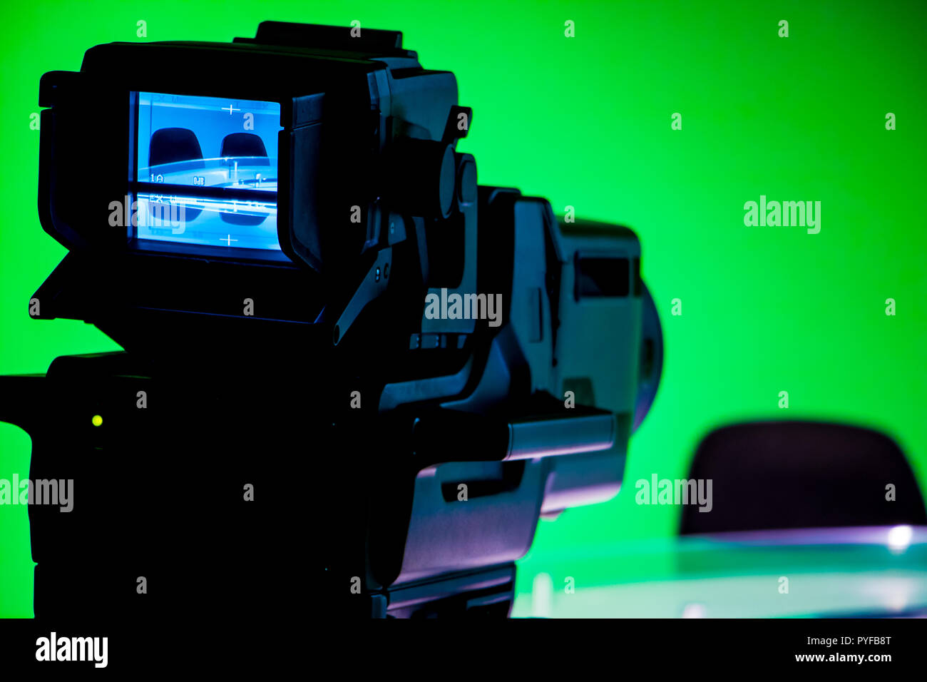 TV studio with professional camera aiming at empty seat, focus on ...