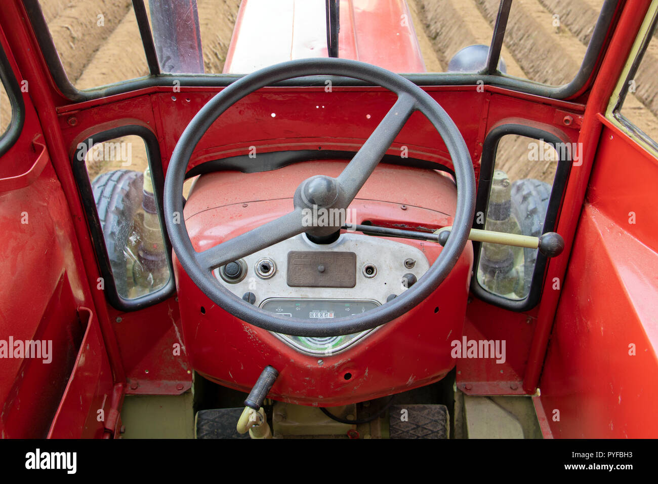The tractor rides in the field, looking from the inside. The interior ...