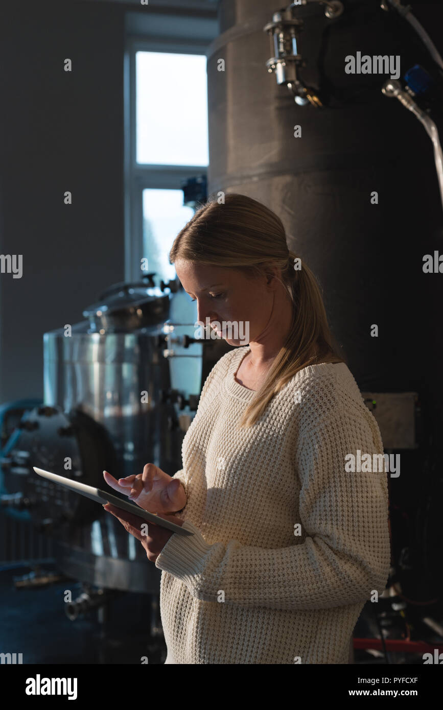 Female worker using digital tablet in factory Stock Photo - Alamy