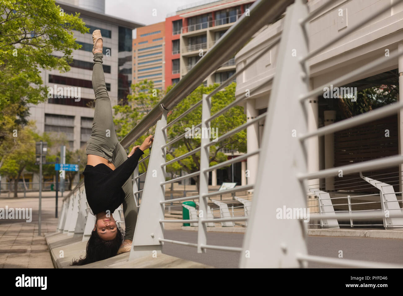 Urban dancer practicing dance on bridge railing Stock Photo - Alamy