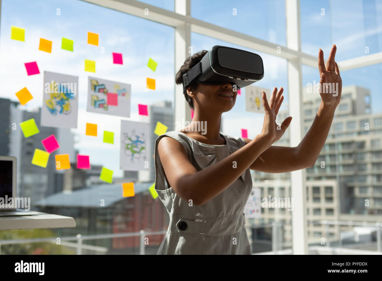 Business executive using virtual reality headset in office Stock Photo ...