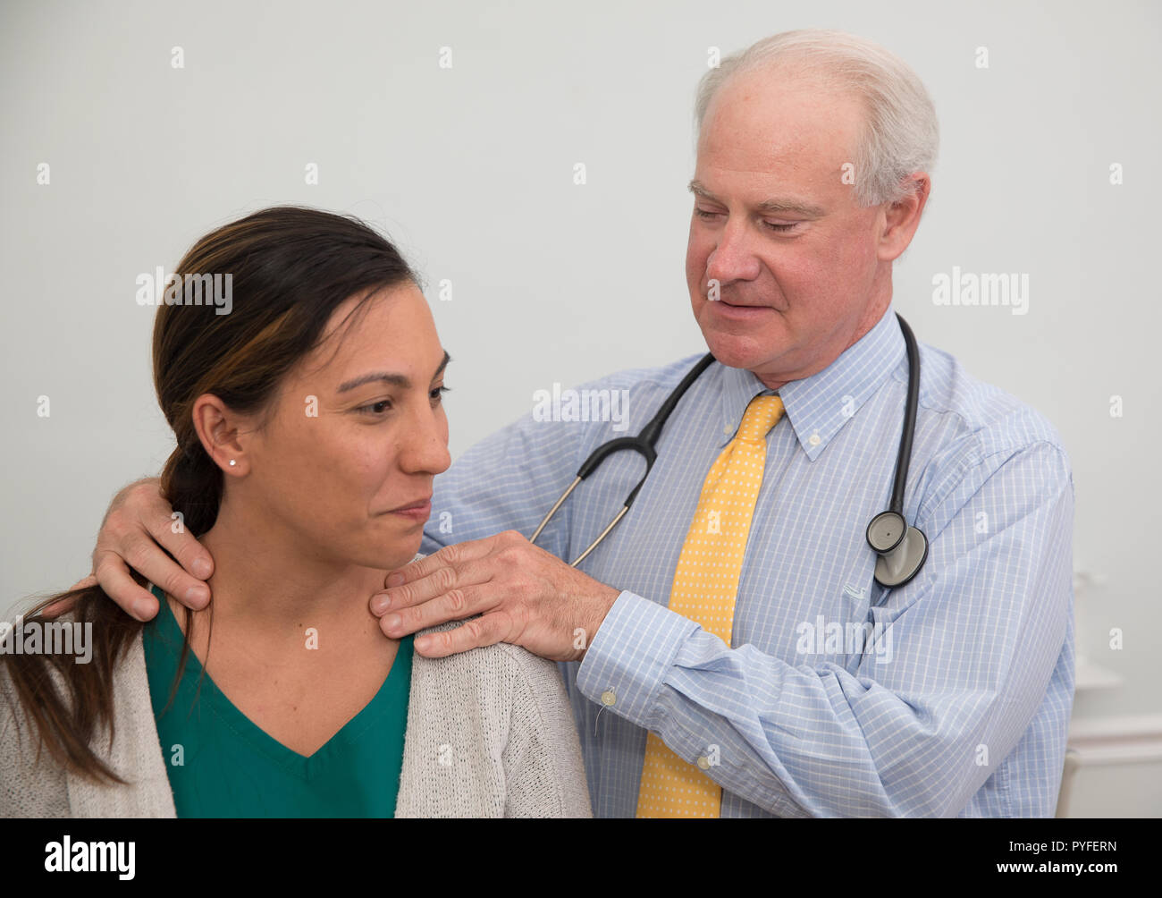 Doctor visits with patient in exam room Stock Photo - Alamy