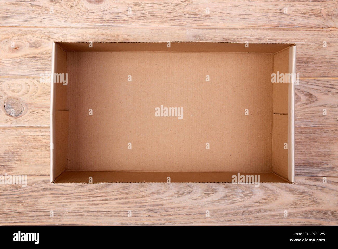 Cardboard box on a white wooden background. top view Stock Photo - Alamy