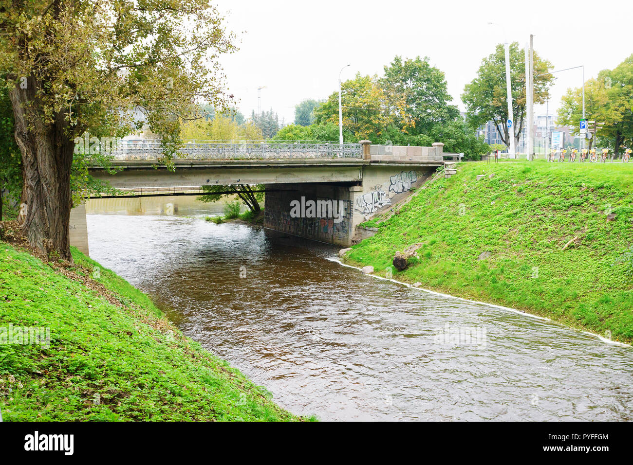 modern bridge across the river flowing in the city Stock Photo - Alamy