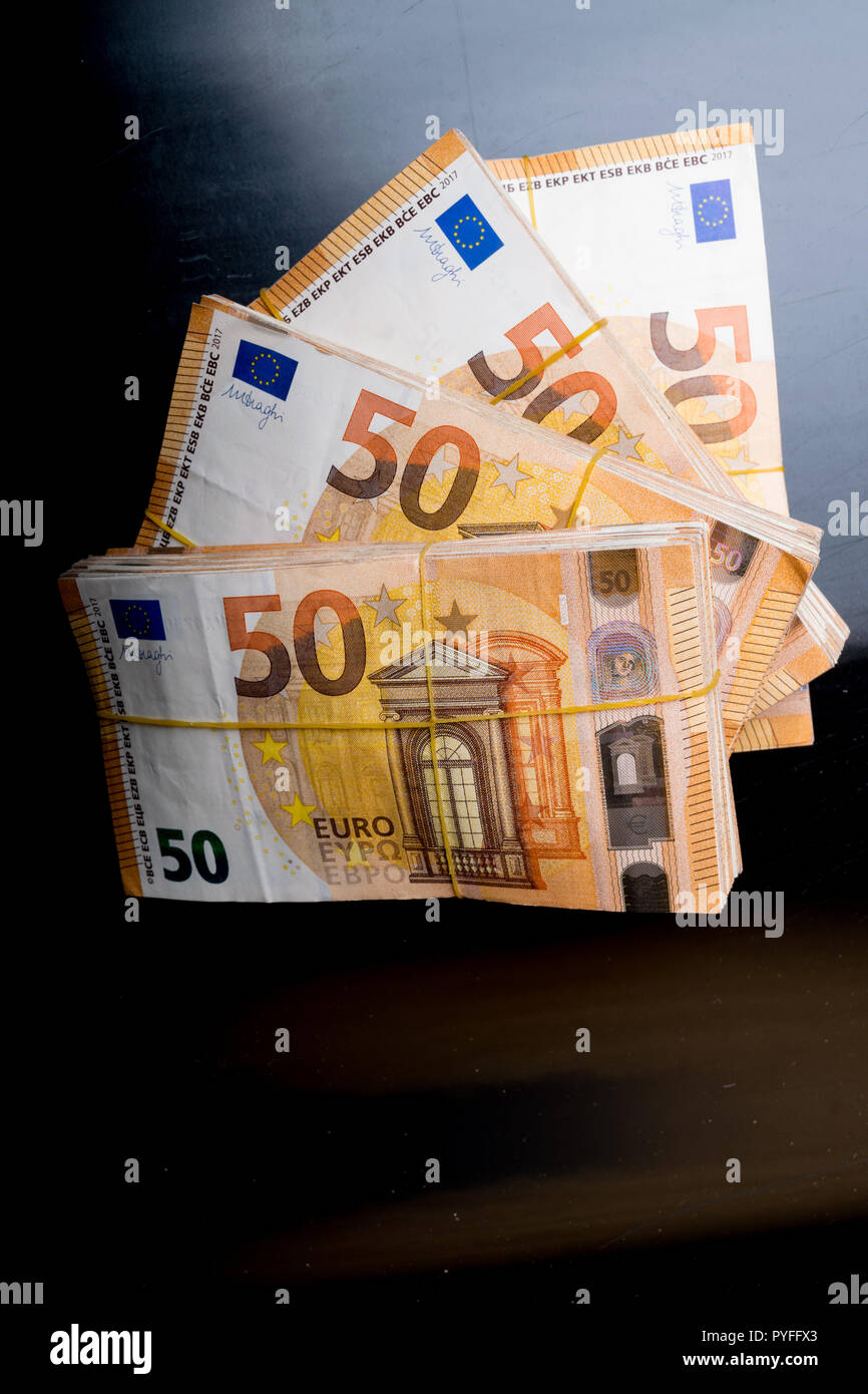 Pile of 50 real euro notes 50-euro banknotes under rubber band isolated ...