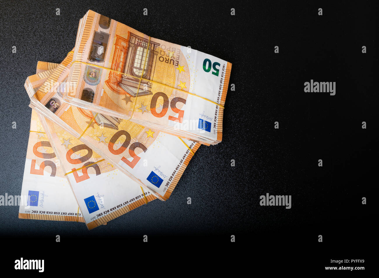 Pile of 50 real euro notes 50-euro banknotes under rubber band isolated ...