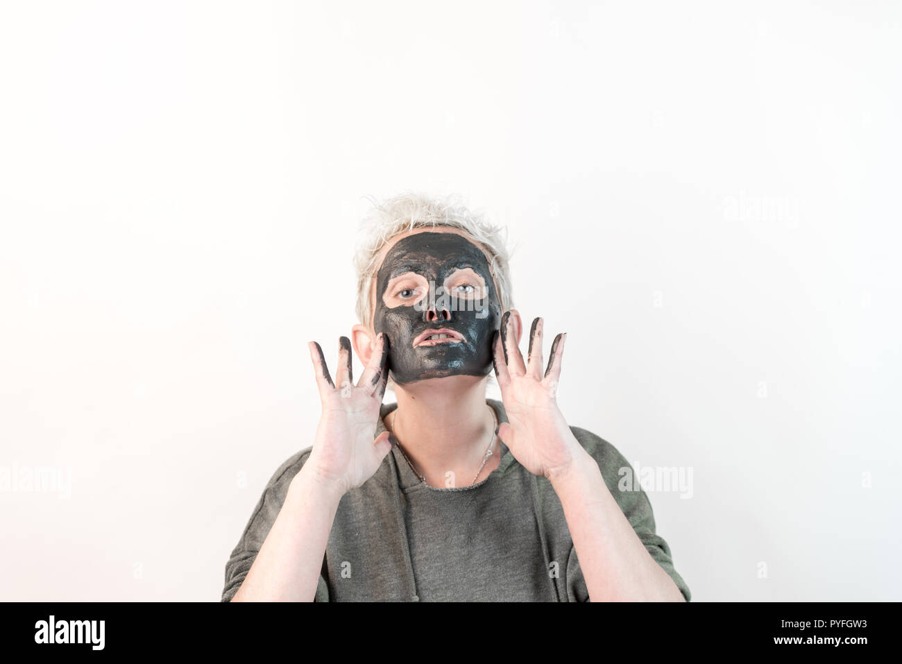 show pure emotions - face of a woman with a black mask showing ...