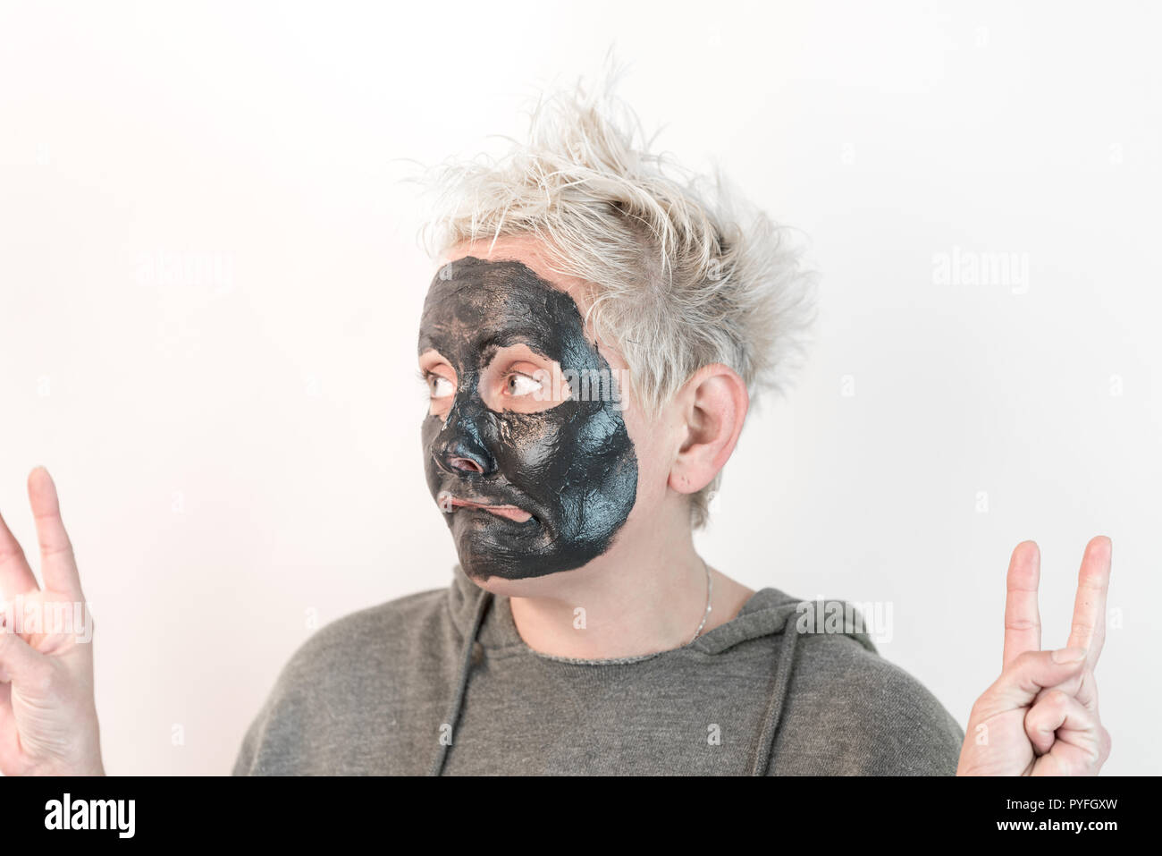 show pure emotions - face of a woman with a black mask showing ...