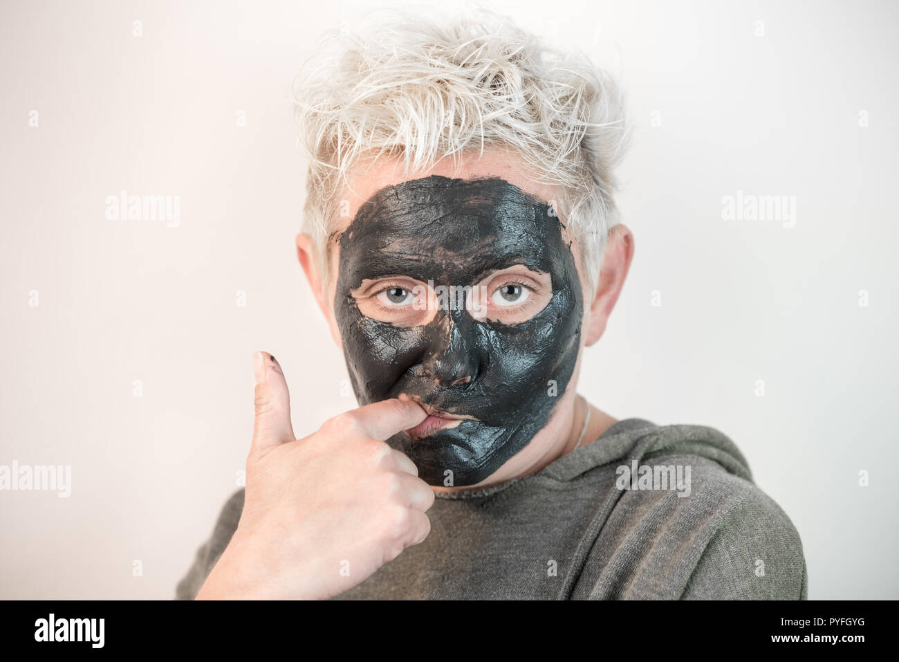 show pure emotions - face of a woman with a black mask showing ...