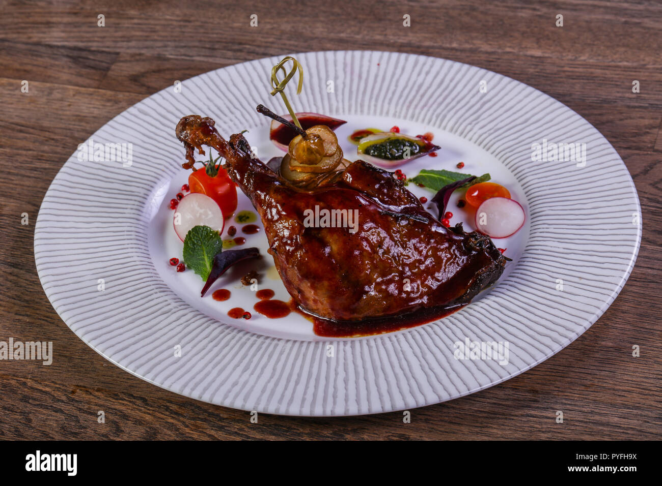 Duck leg with pear and sauce Stock Photo - Alamy