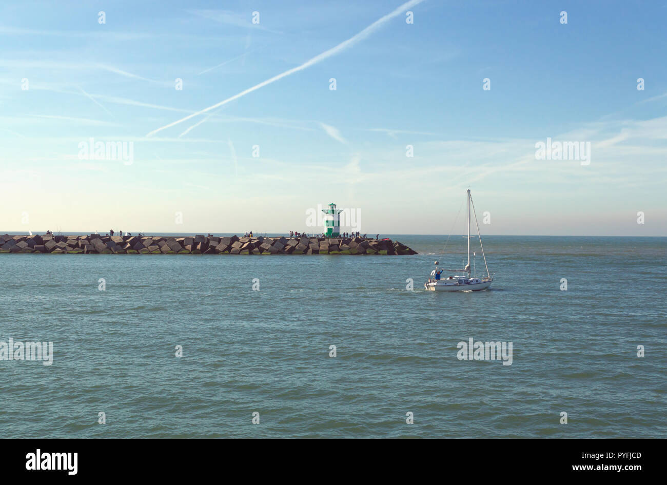 view from pier at scheveningen beach on another pier with lighthouse ...