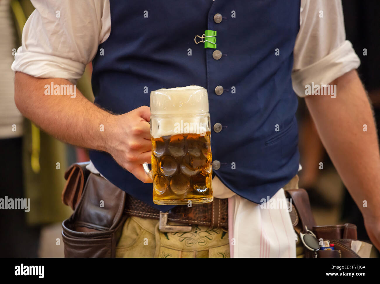 Oktoberfest, Munich, Germany. Waiter with traditional costume holding ...