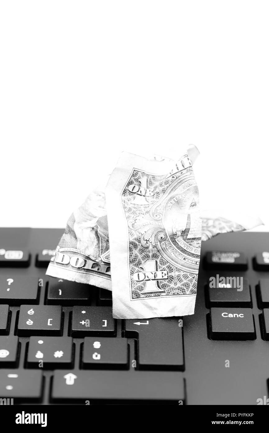 blurred crumpled dollar money background in a keyboard like concept of ...