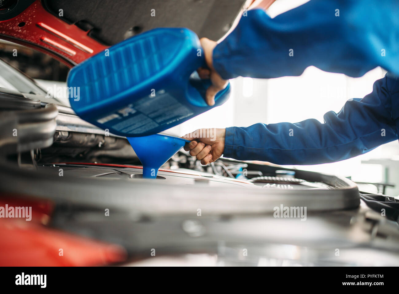 Technician change oil in the car engine. Vehicle motor maintenance ...