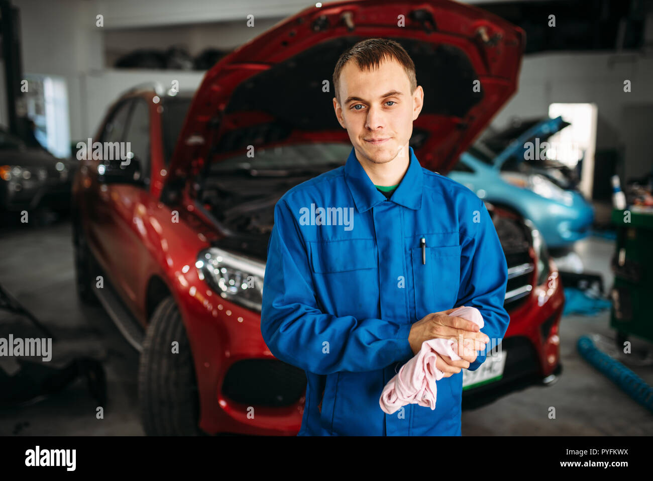 Mechanic wipes his hands after repairing the car, motor diagnostic ...
