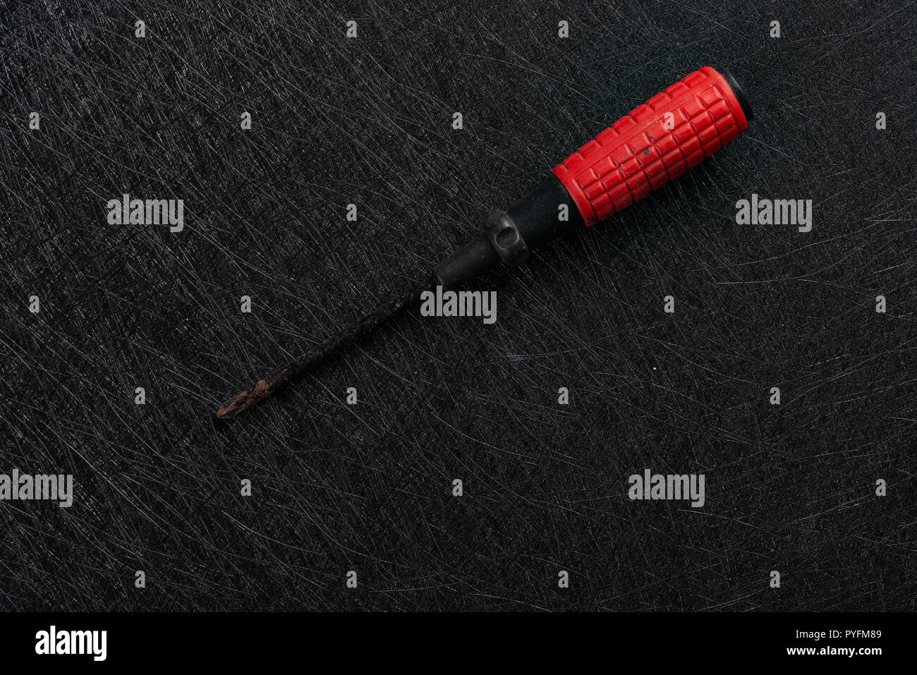 top view phillips screw driver on a dark background Stock Photo - Alamy