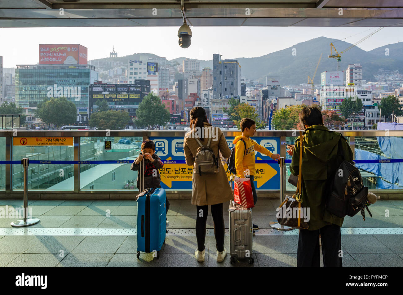 A group of friends with cases depart Busan railway station having ...