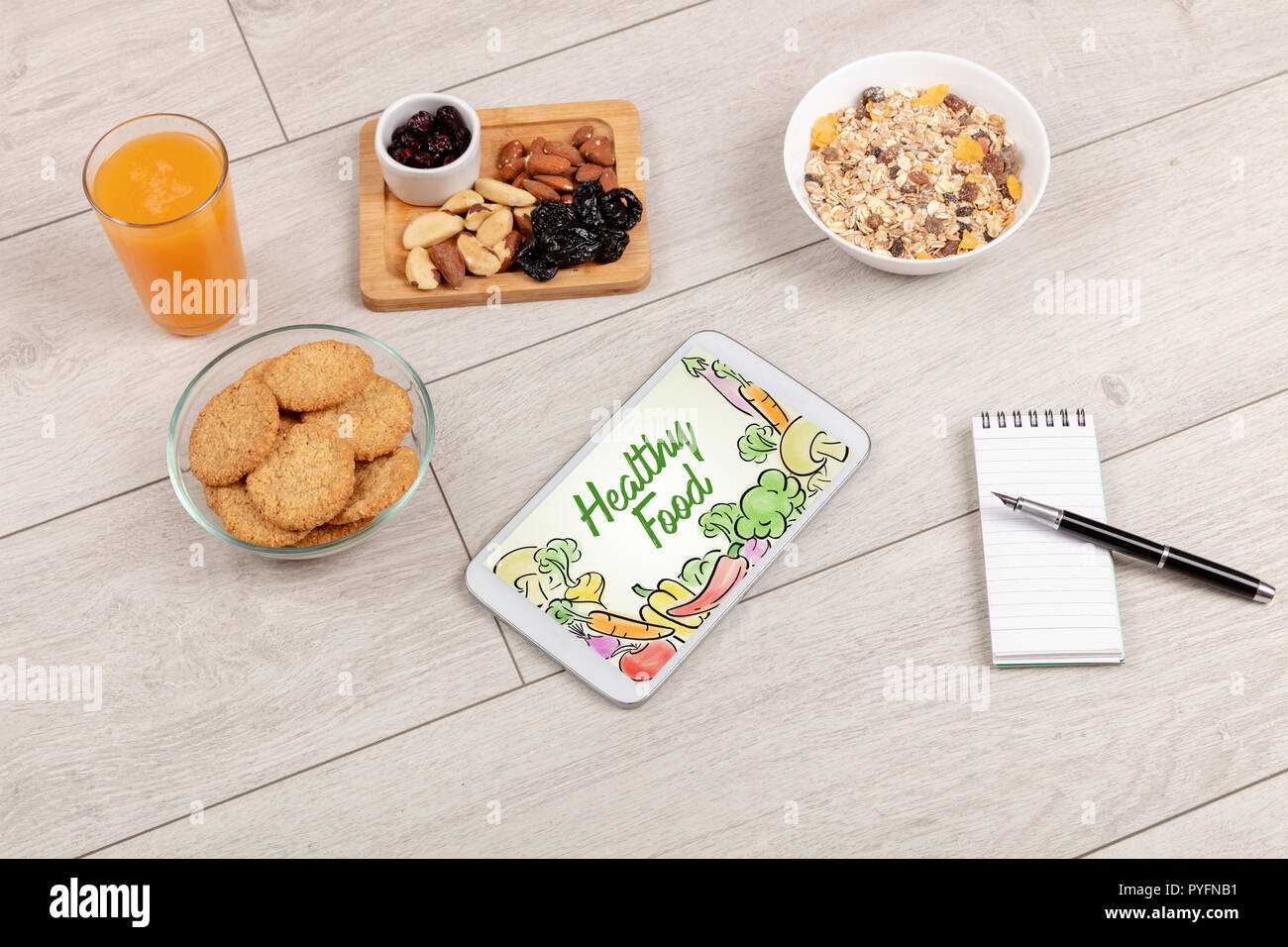 Healthy food composition with tablet Stock Photo - Alamy