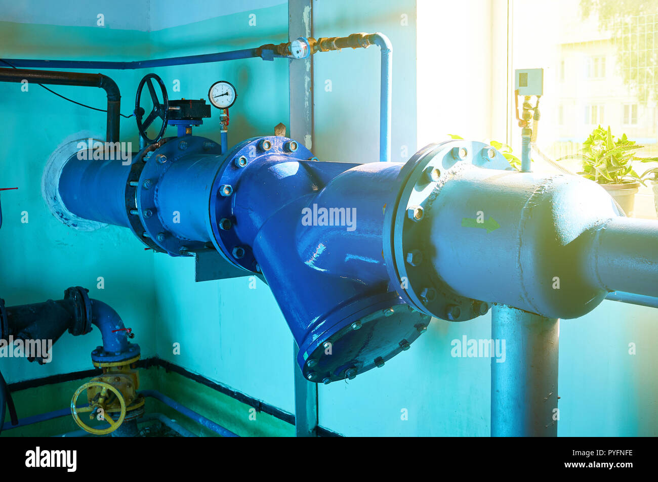 Gate valves installed on pipes painted in blue. Industrial background ...