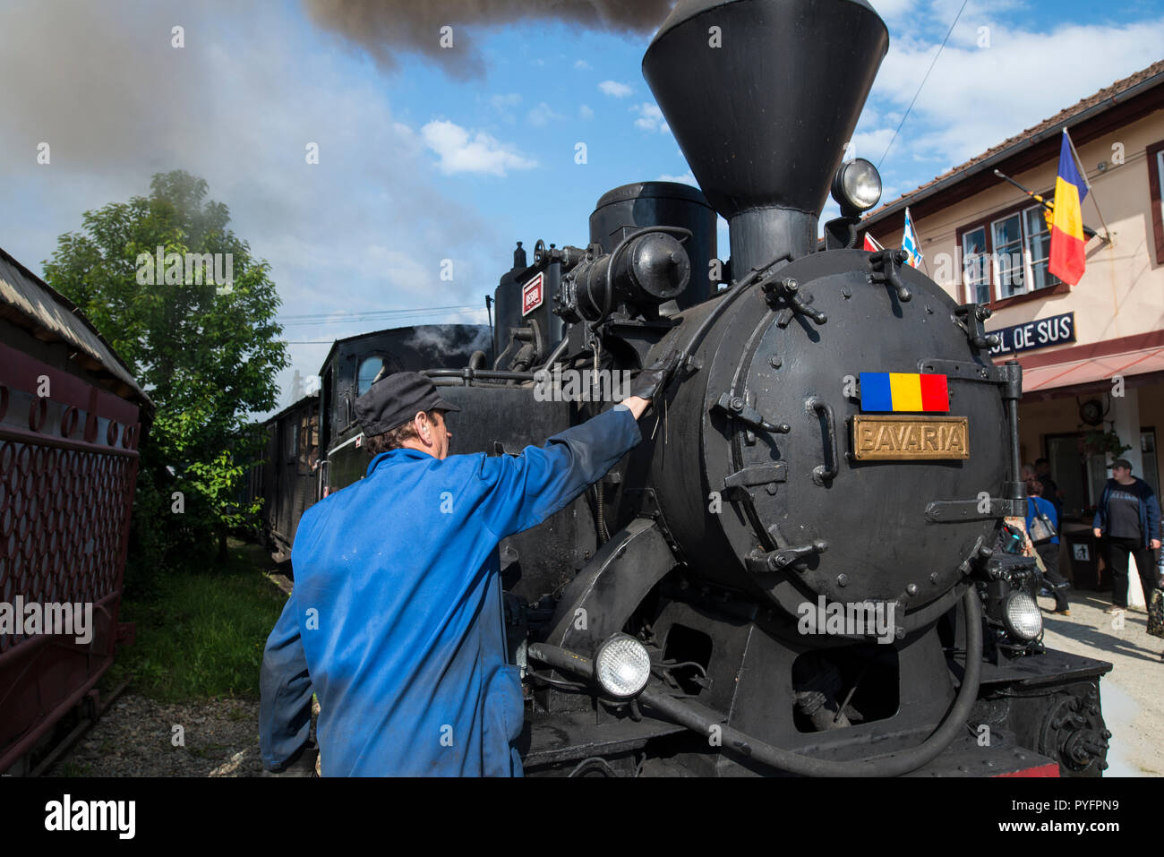 ROMANIA, VISEU DE SUS. Train driver checking the historic engine ...