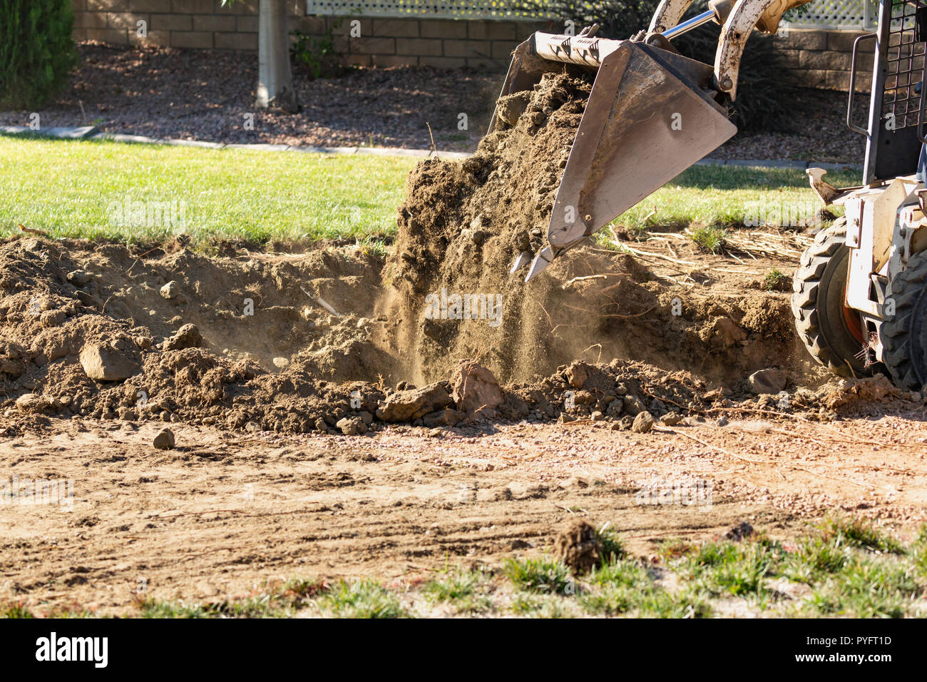 Small Bulldozer Digging In Yard For Pool Installation Stock Photo - Alamy