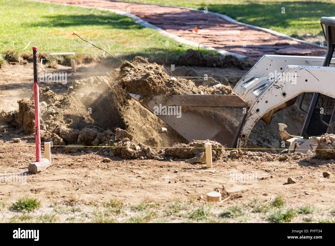 Small Bulldozer Digging In Yard For Pool Installation Stock Photo - Alamy