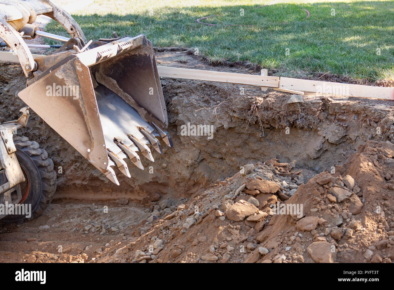 Small Bulldozer Digging In Yard For Pool Installation Stock Photo - Alamy