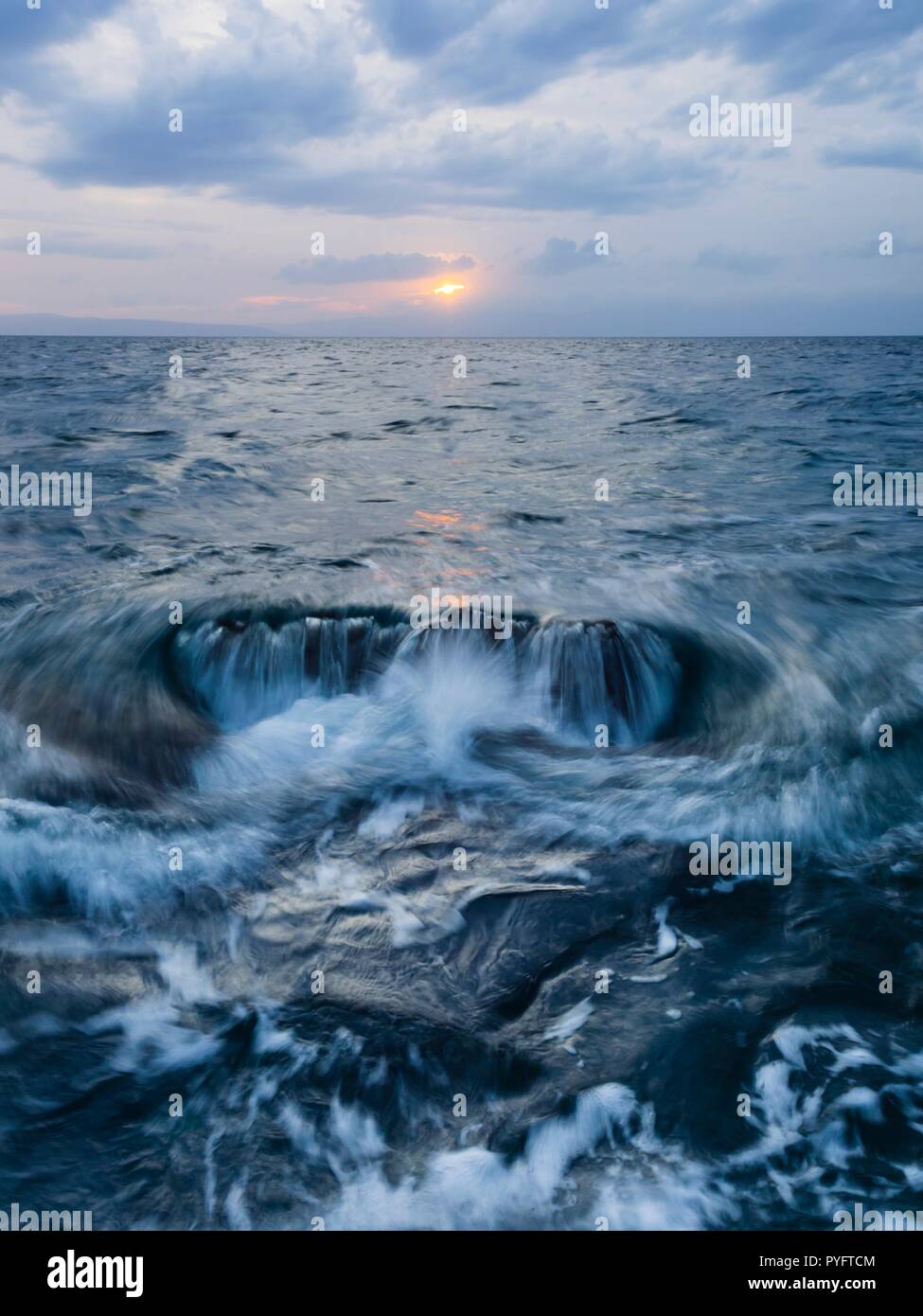 Dynamic sea waves striking rock mid-long exposure Stock Photo - Alamy