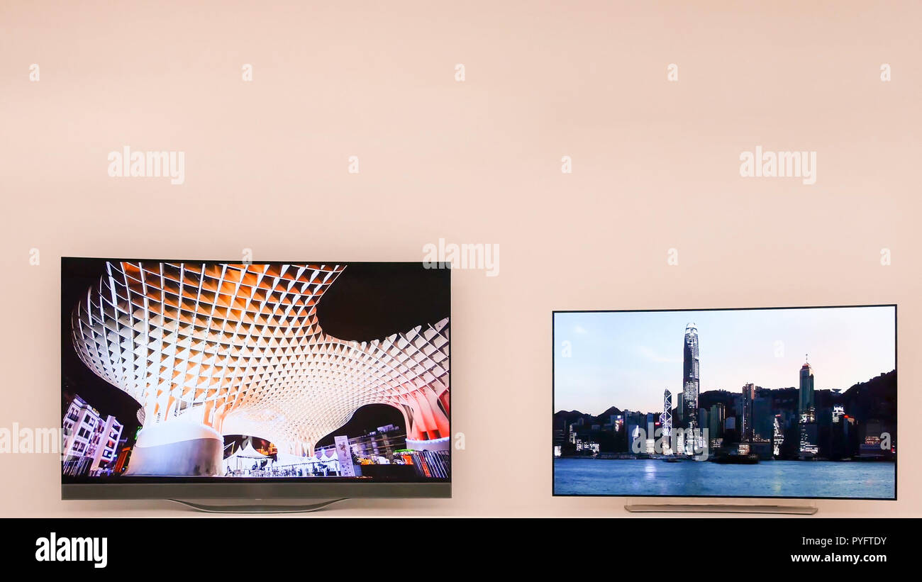 Modern flat screen televisions with pink background and space for text ...