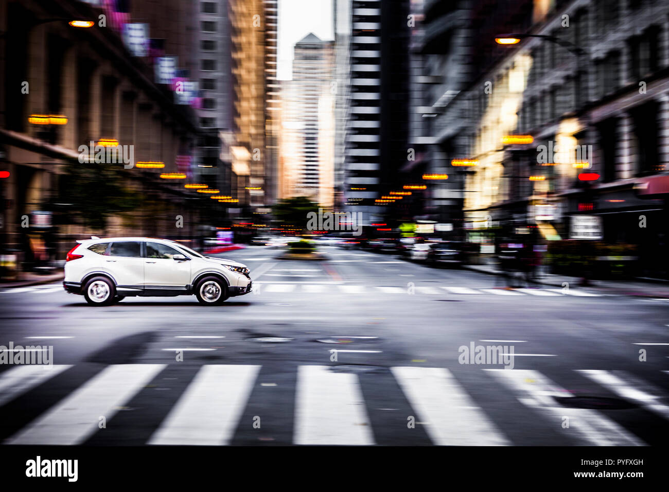 Panning of a car crossing an intersection in downtown Chicago. In the ...