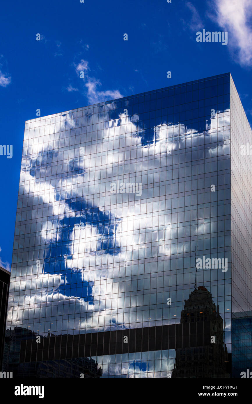 Clouds reflecting off of a modern glass building Stock Photo - Alamy