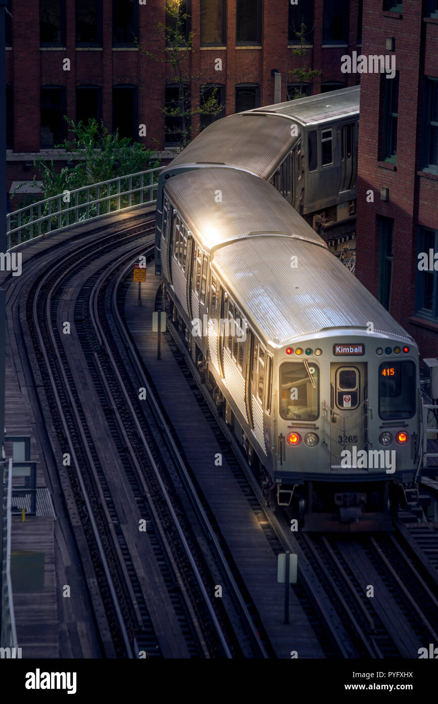 Commuter train on curved, elevated train tracks in downtown Chicago ...