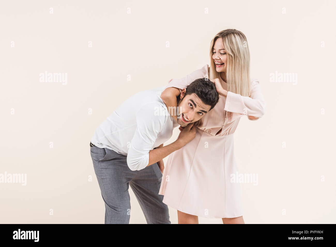happy young couple having fun together isolated on beige Stock Photo ...